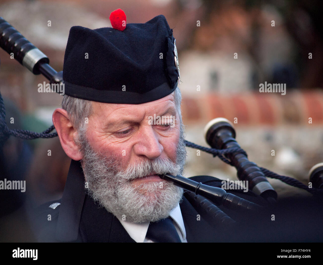 An elderly Scotsman plays his bagpipes Stock Photo - Alamy
