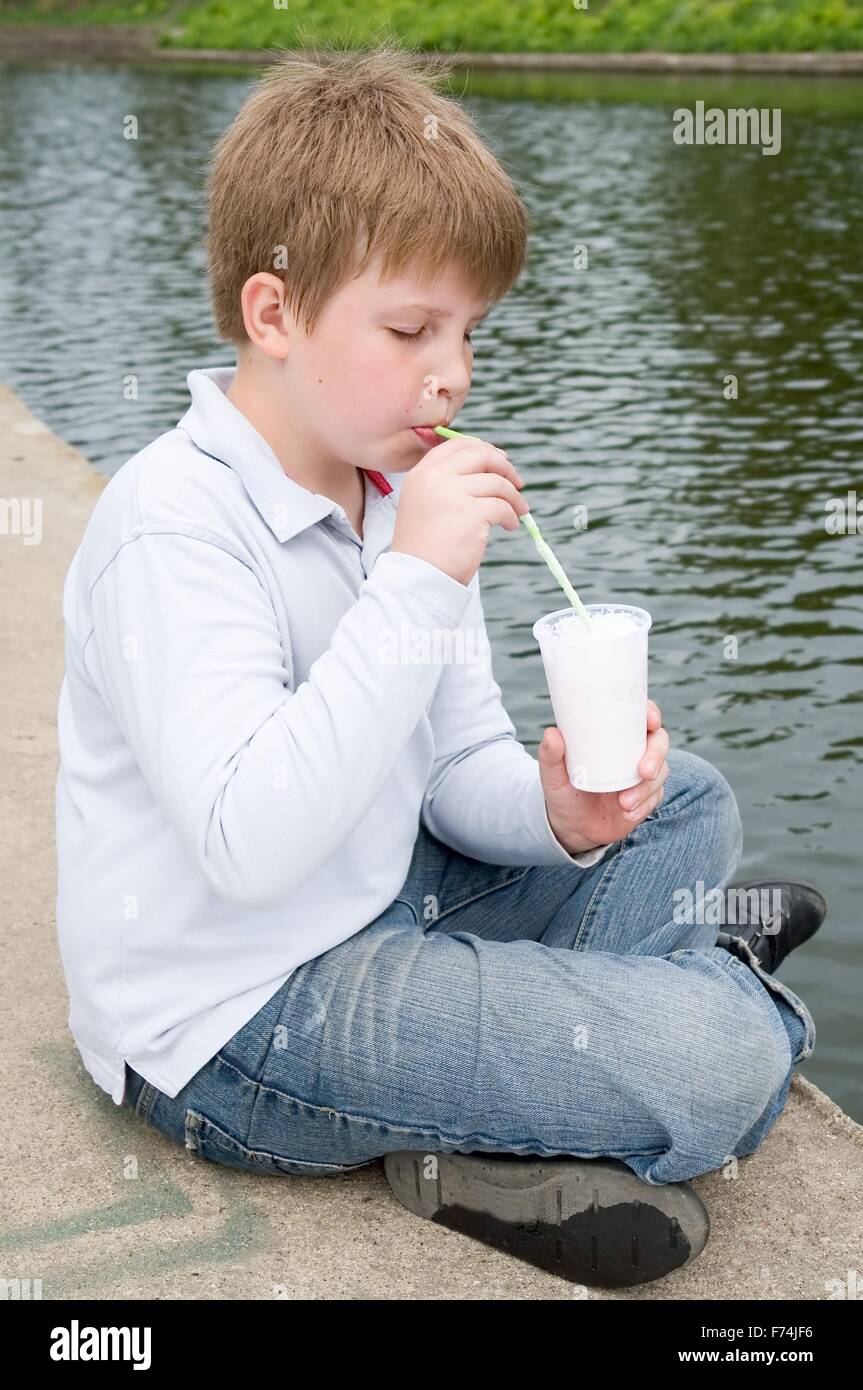 little boy drinks milkshake Stock Photo - Alamy