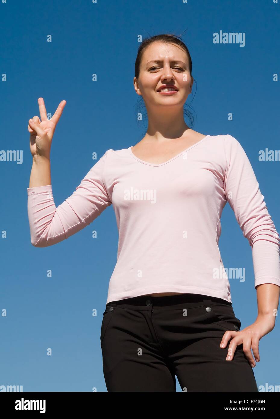 girl with victory gesture Stock Photo - Alamy