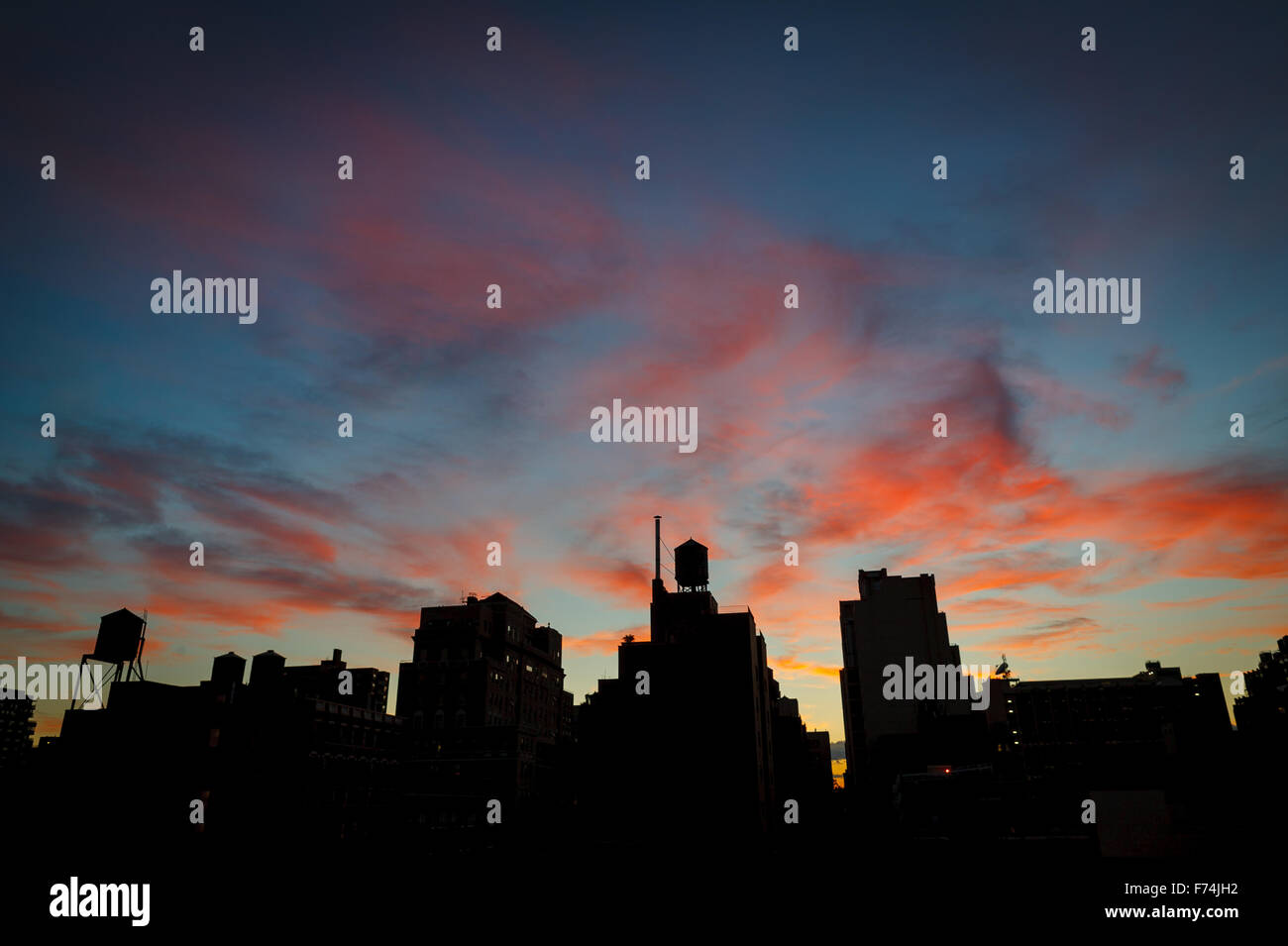 Twilight draws the contours of Chelsea rooftops and water towers under ...