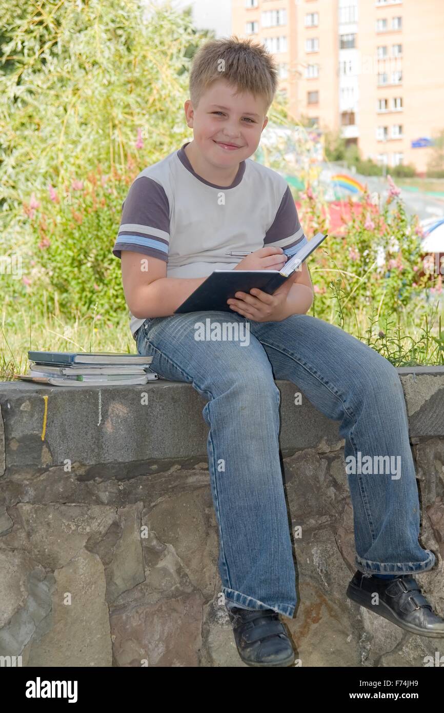 boy writes to writing-books Stock Photo - Alamy