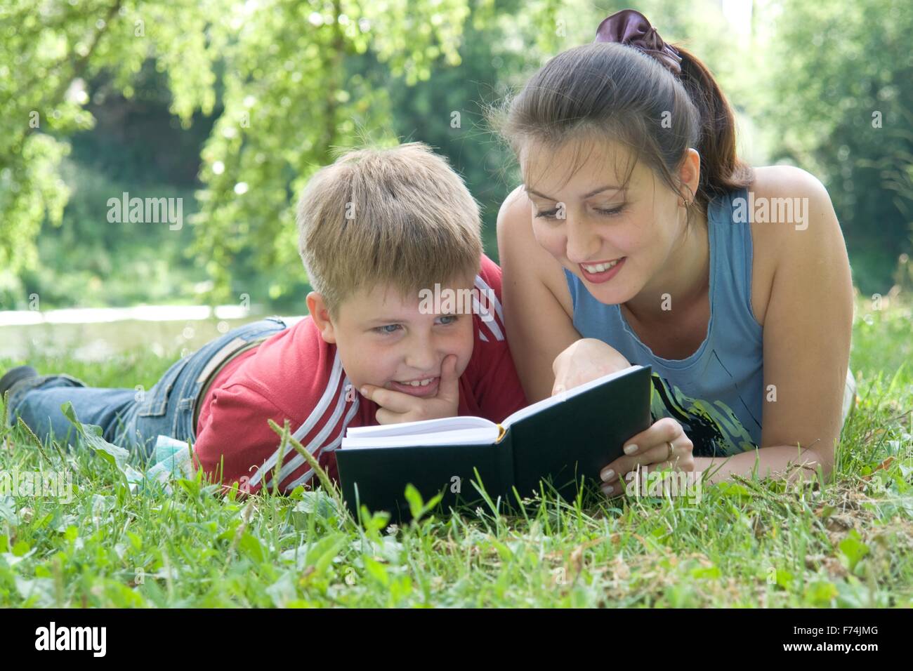 Mum and the son reads Stock Photo - Alamy