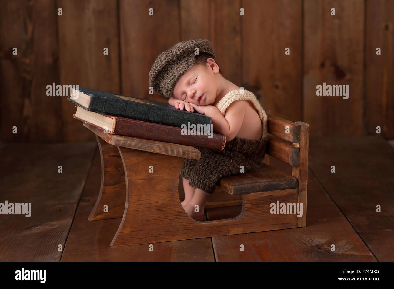 Newborn Baby Boy Sleeping on a Tiny School Desk Stock Photo - Alamy