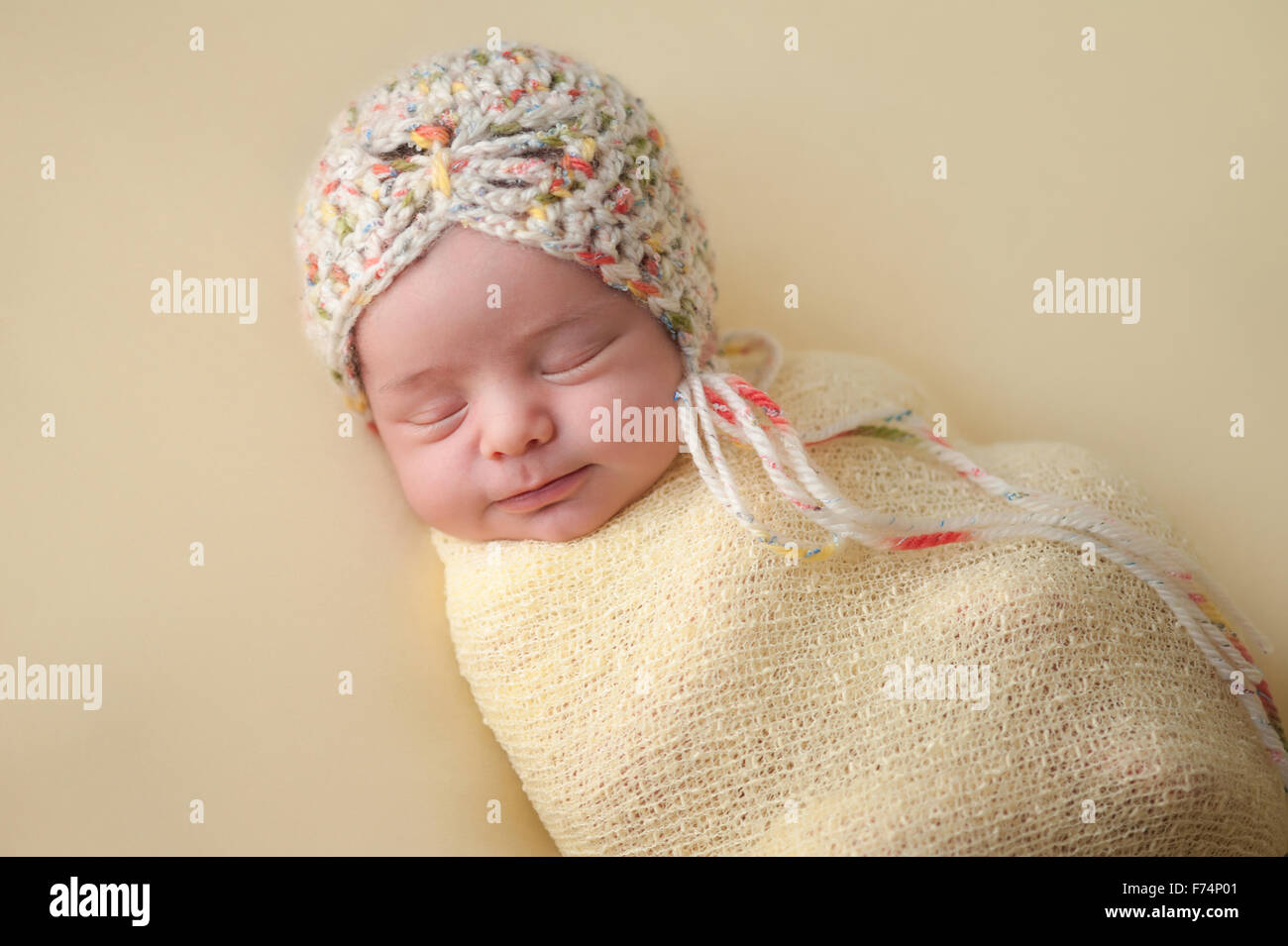 A portrait of a beautiful, two week old, newborn baby girl wearing a ...