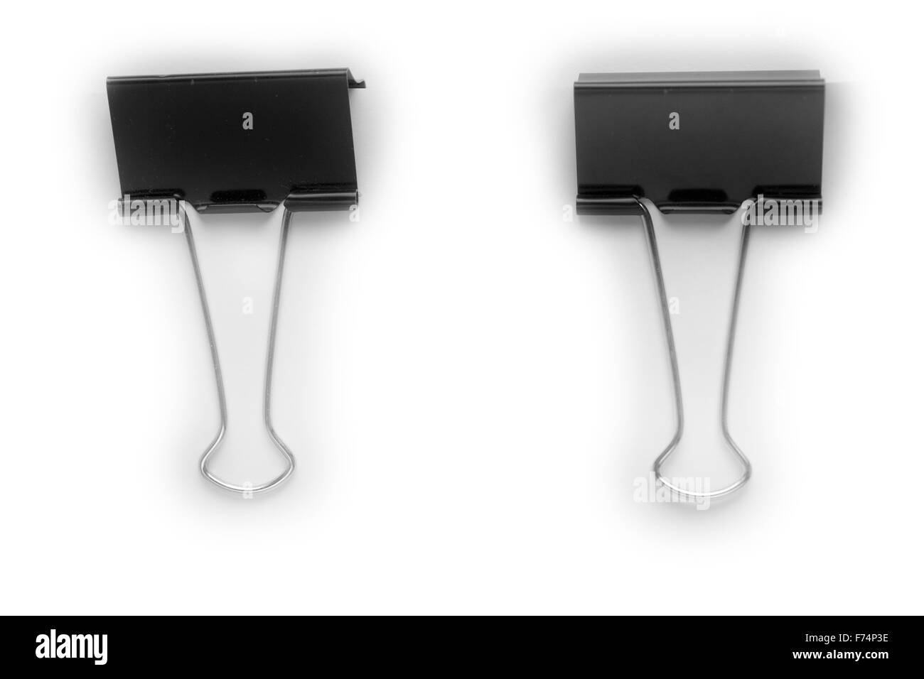 Two black metal clips Stock Photo - Alamy