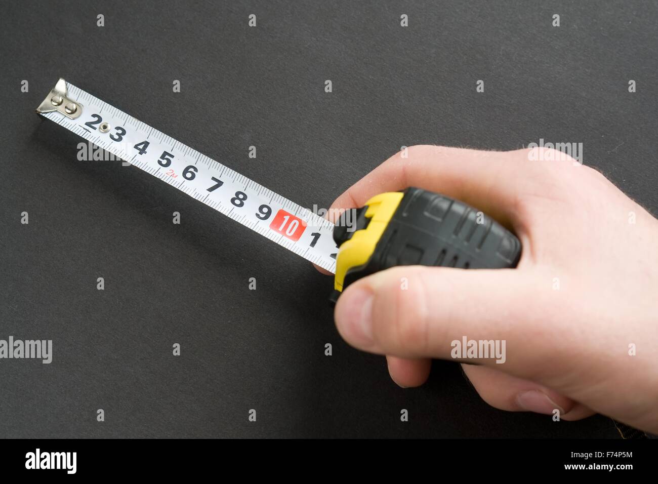 Hand with a measuring tape Stock Photo - Alamy