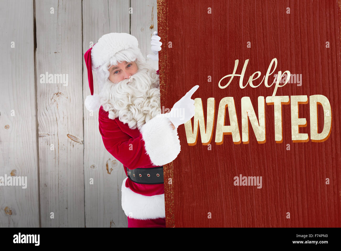 Composite image of smiling santa claus pointing poster Stock Photo - Alamy