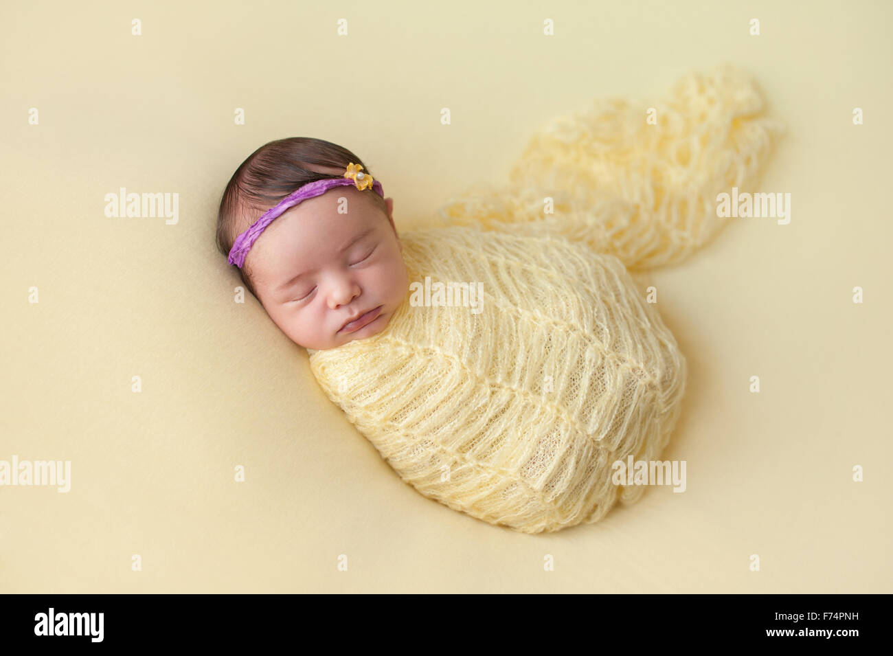 A portrait of a beautiful, sleeping, two week old, newborn baby girl ...