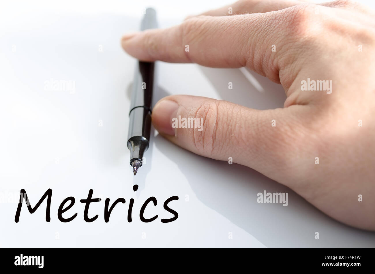 Metrics text concept isolated over white background Stock Photo - Alamy