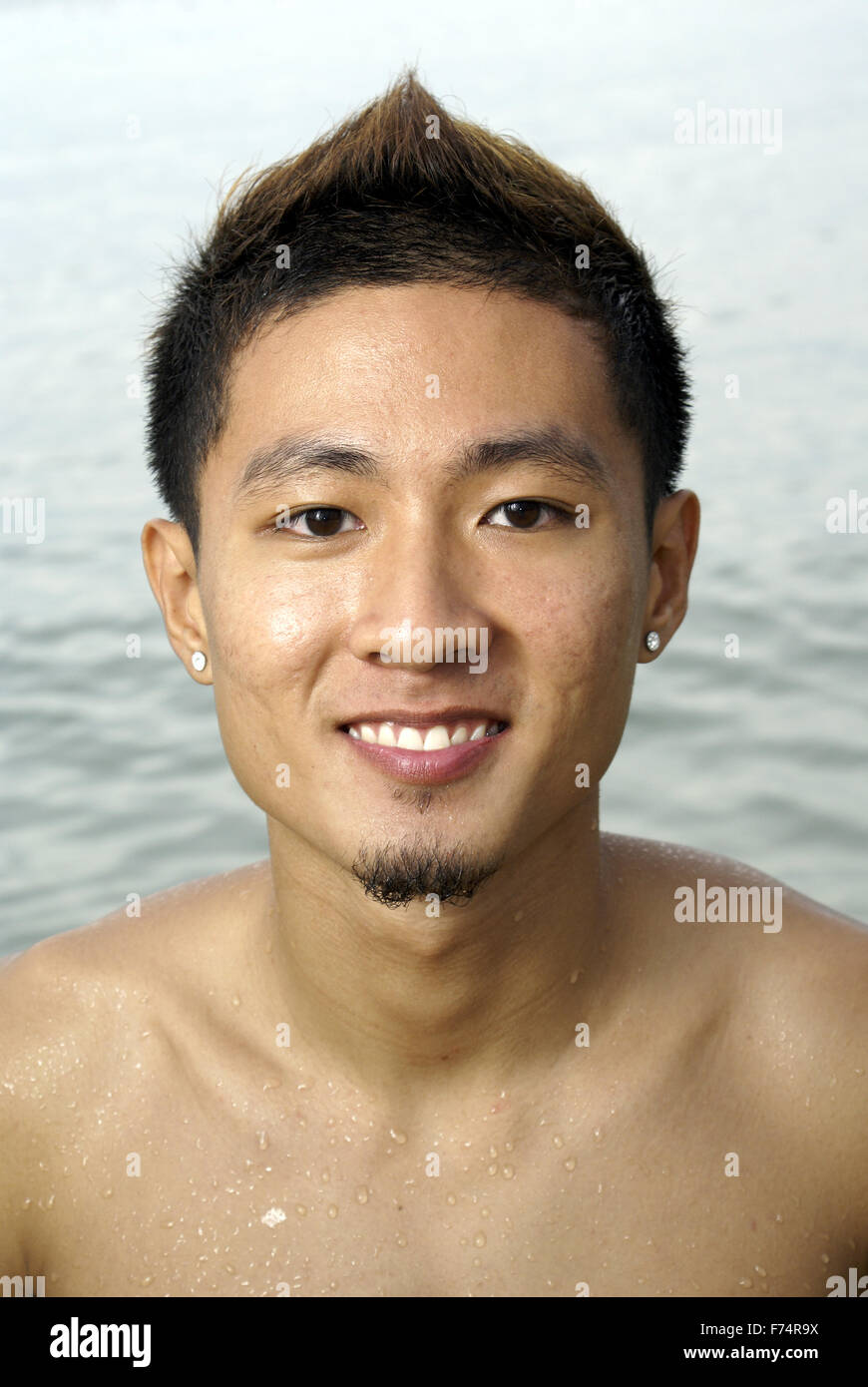 Chinese asian man at beach Stock Photo - Alamy