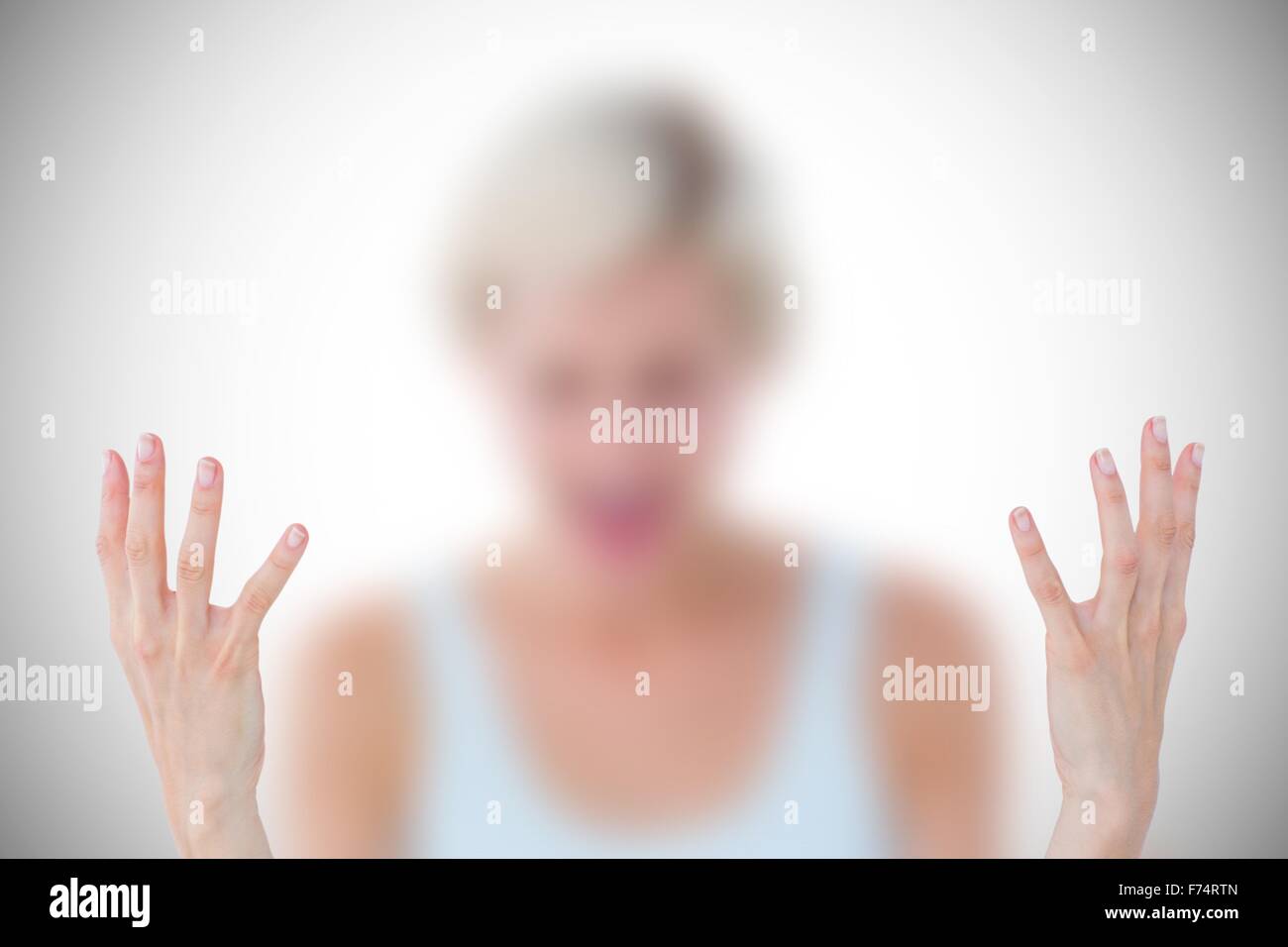 Composite image of angry blonde yelling with hands up Stock Photo - Alamy