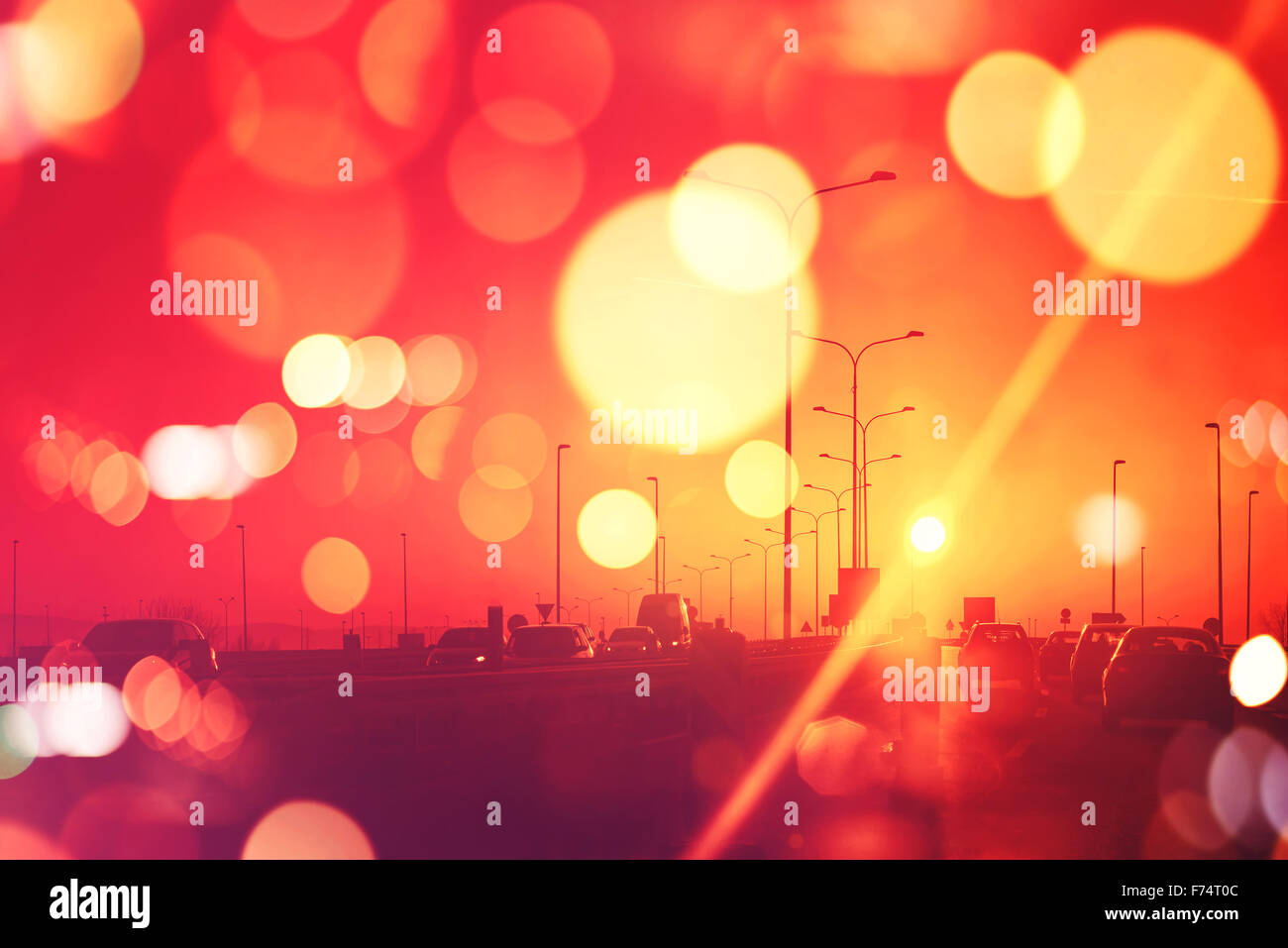 City traffic in sunset, cars on Roadway,retro toned image with bokeh ...