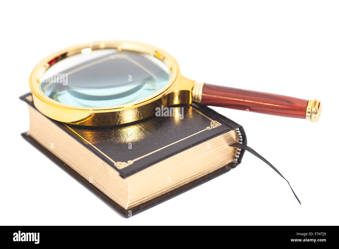 Book with magnifying glass over white background Stock Photo - Alamy