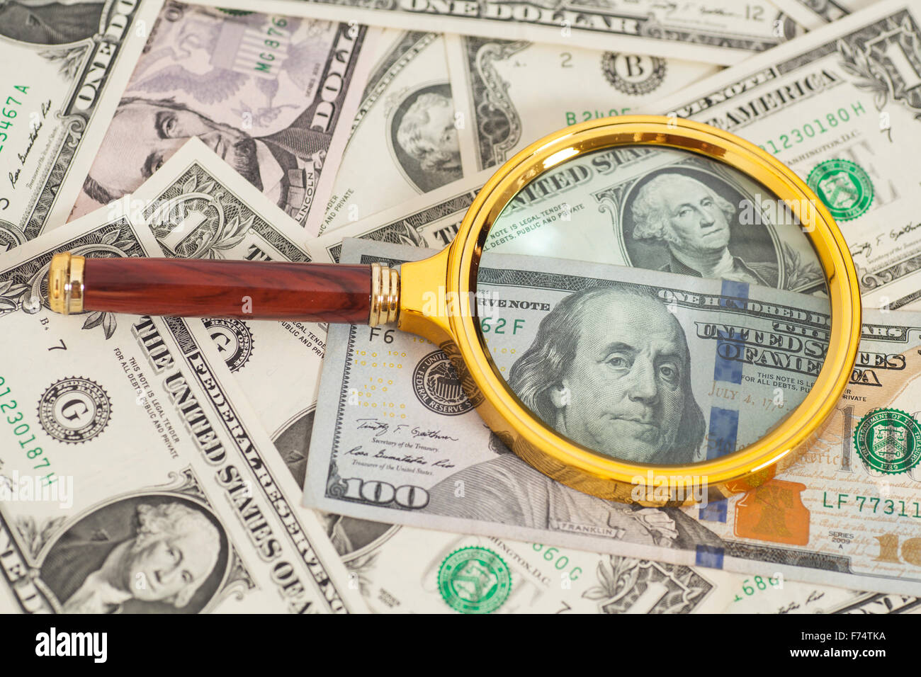 dollar banknotes under magnifying glass Stock Photo - Alamy
