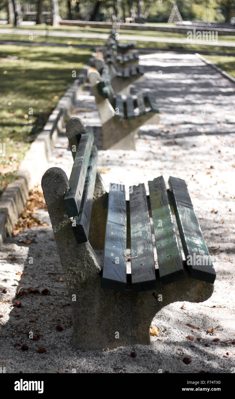 Photo of a line of benches in the park Stock Photo - Alamy