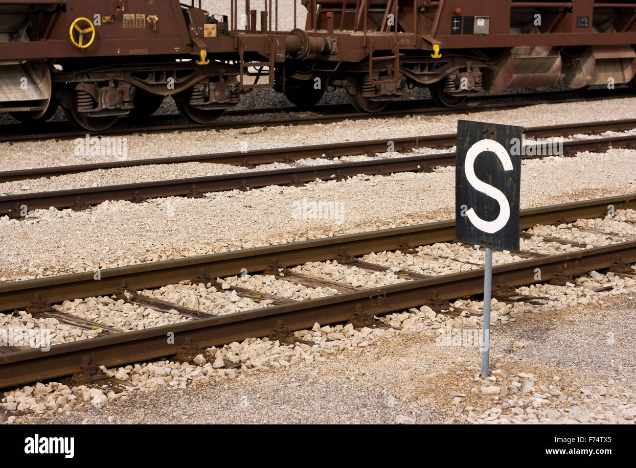 Train station stop with sign Stock Photo - Alamy