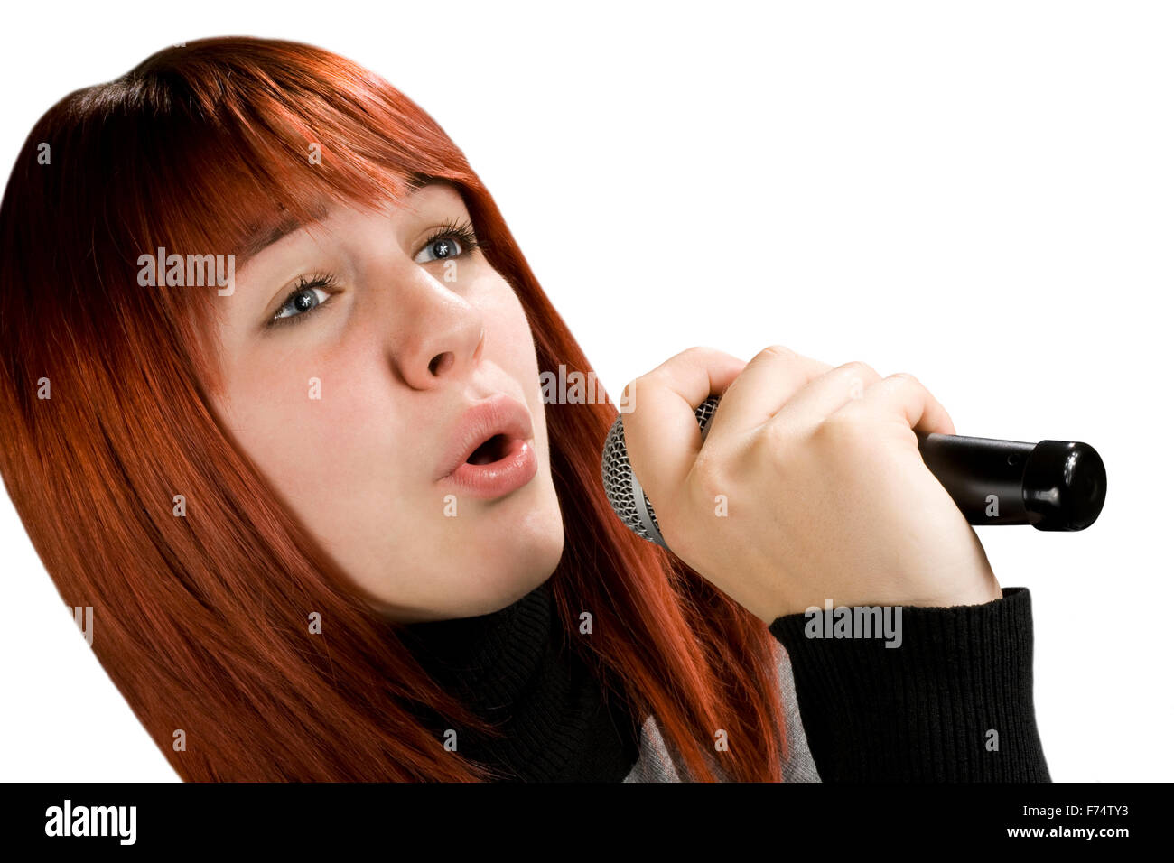 Girl singing on microphone Stock Photo - Alamy