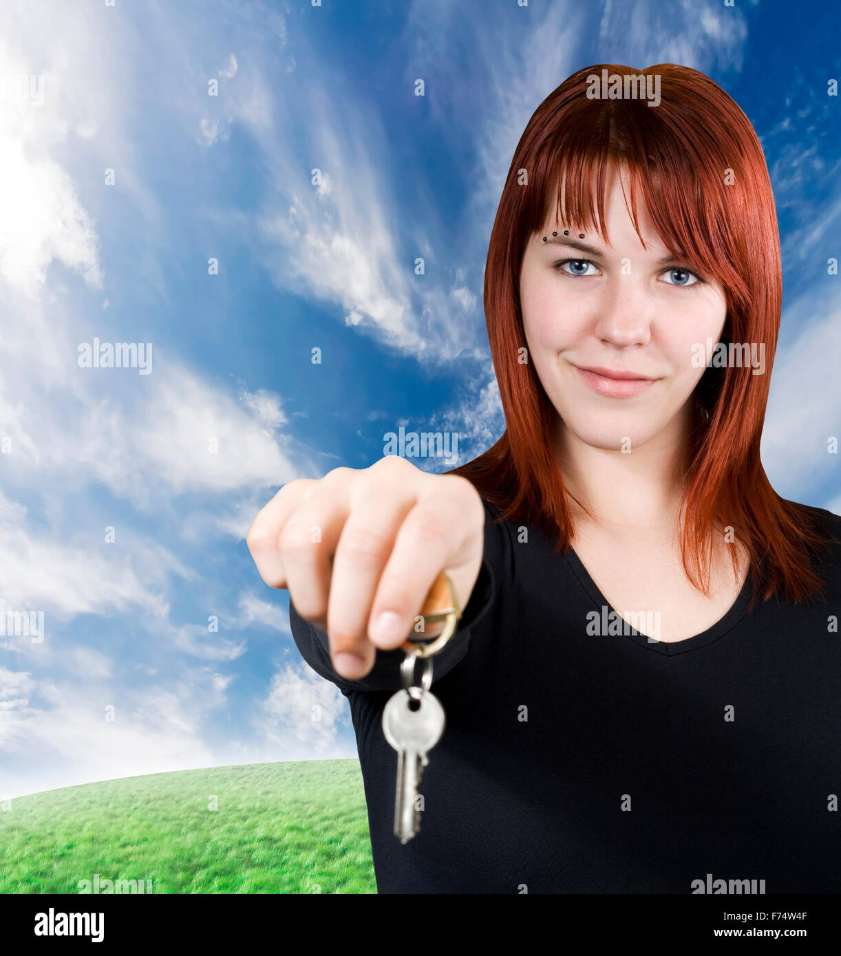 Redhead girl passing keys Stock Photo - Alamy