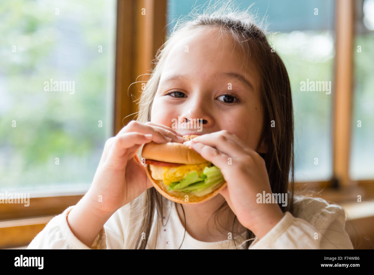 Woman eating big burger hi-res stock photography and images - Alamy