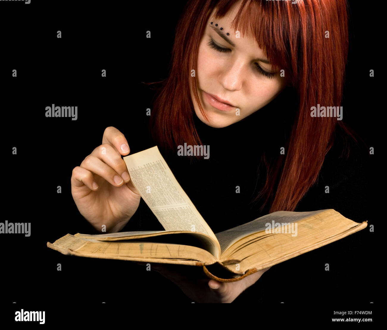 Girl turning book pages Stock Photo - Alamy