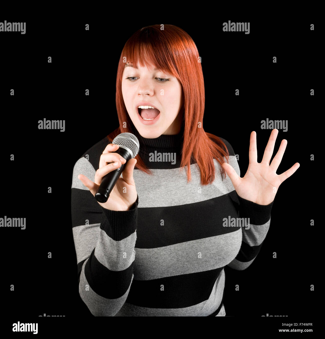 Redhead girl singing karaoke on microphone Stock Photo - Alamy