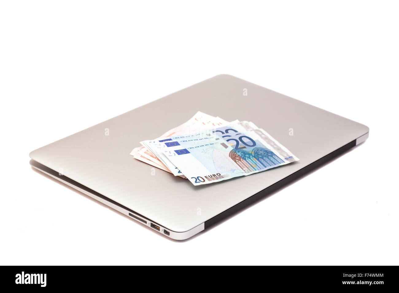 Laptop With Euro money isolated on white Stock Photo - Alamy
