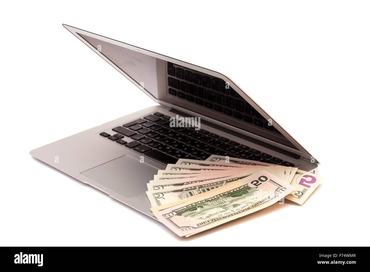 Open Laptop With Dollars money isolated Stock Photo - Alamy