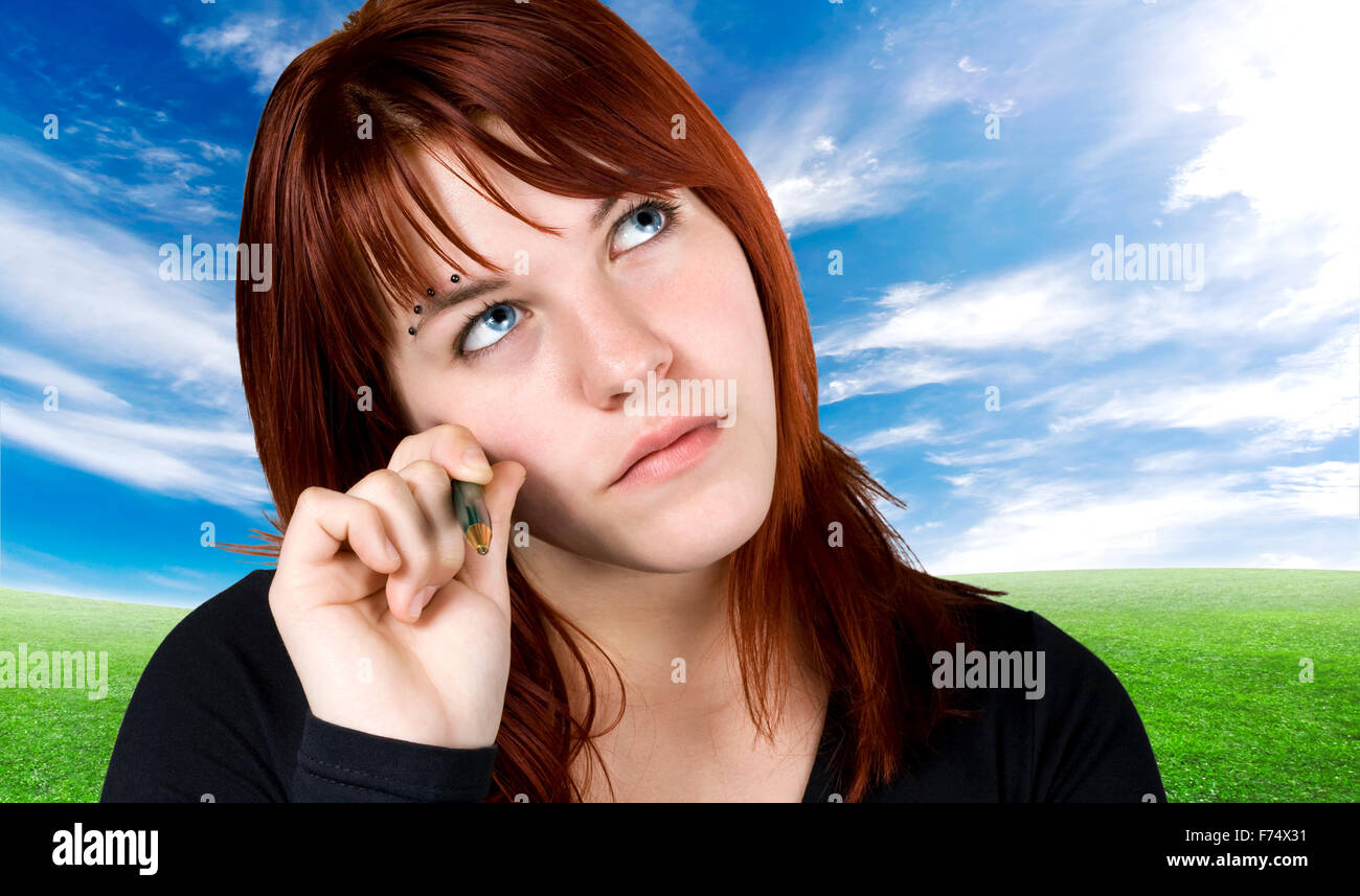 Cute redhead in dilemma Stock Photo - Alamy