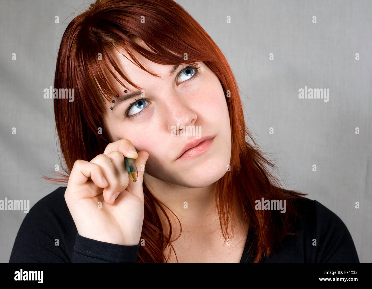 Cute redhead in dilemma Stock Photo - Alamy