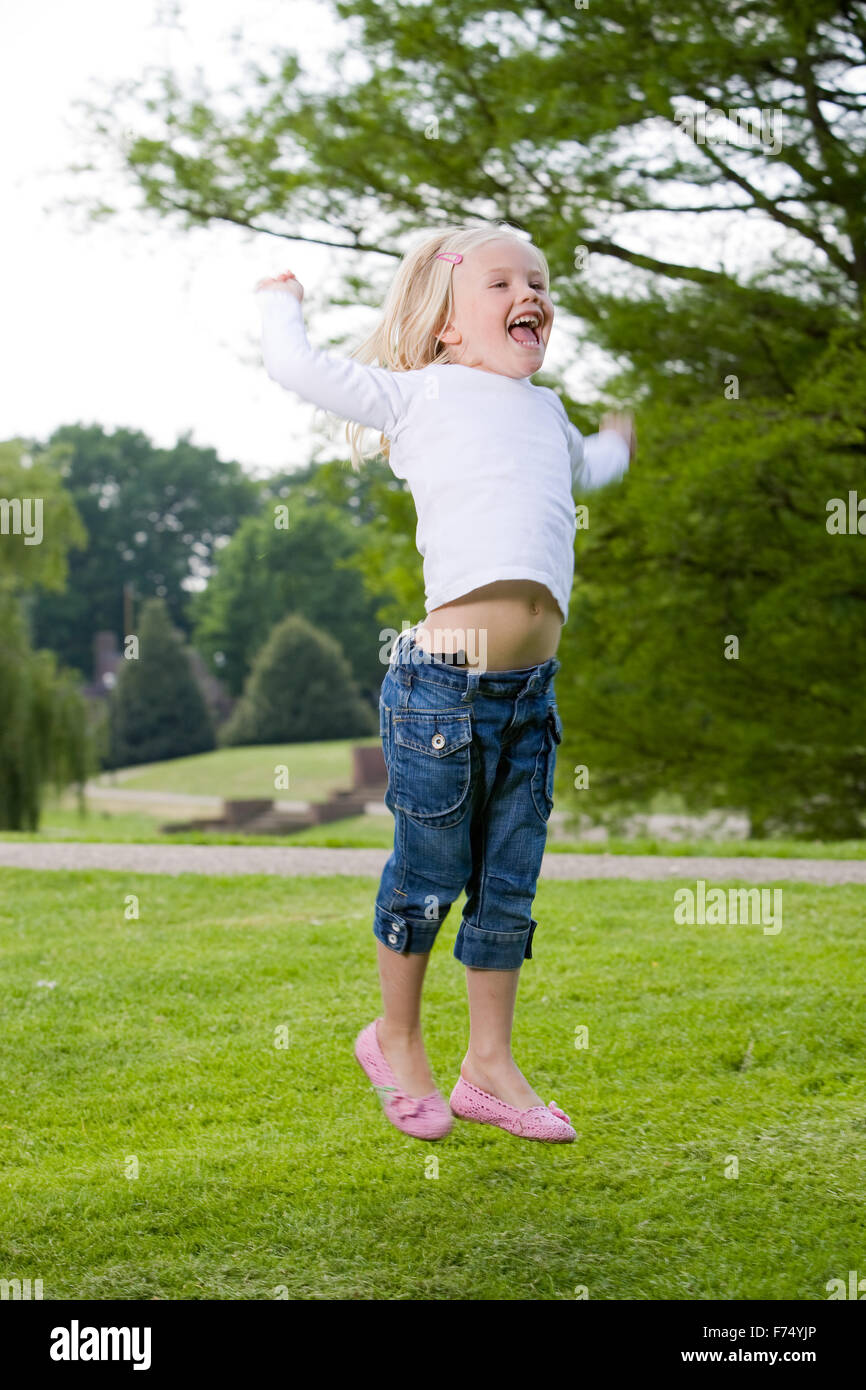 Happy kids fun jump hi-res stock photography and images - Alamy