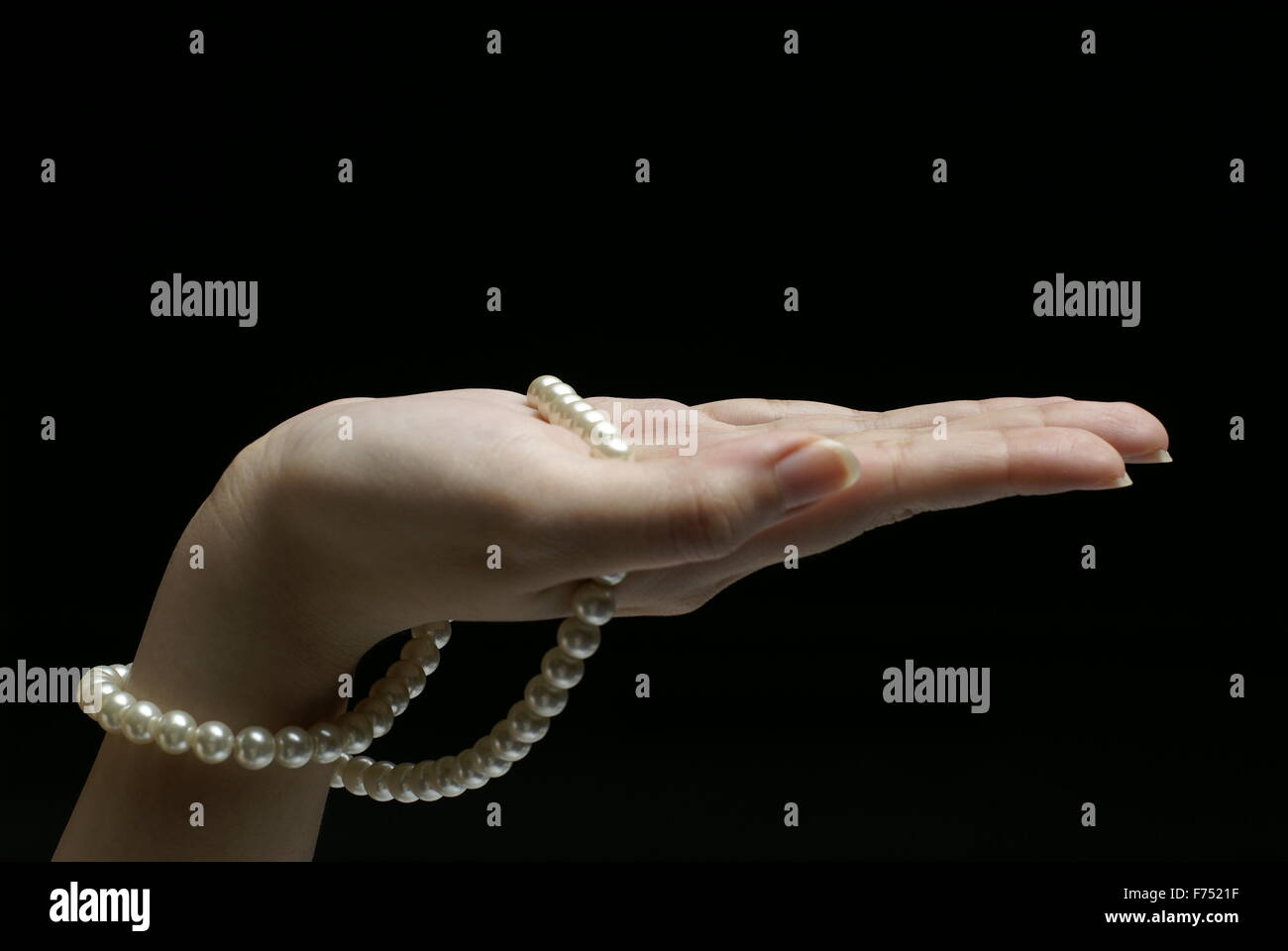 Female hand with pearls Stock Photo - Alamy
