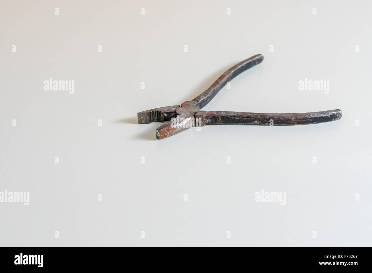 Old rusty pliers on a bright surface Stock Photo - Alamy
