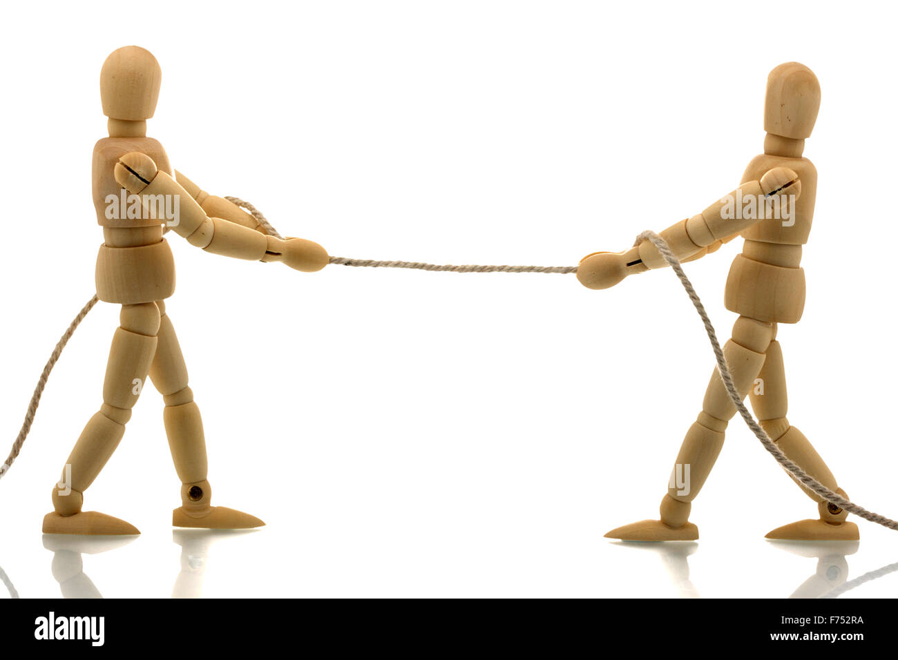 Two manikins pulling a rope Stock Photo - Alamy