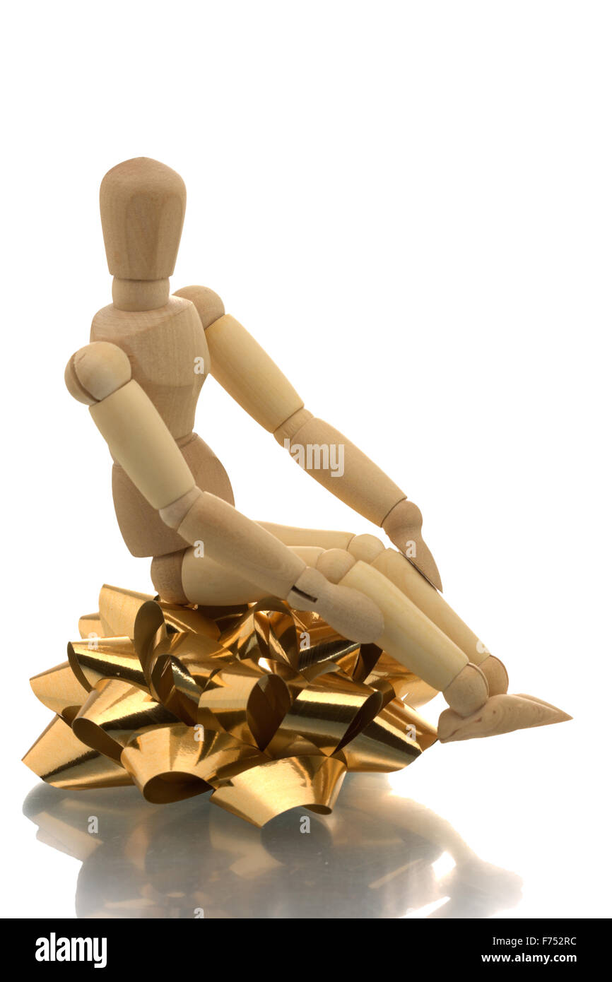 Manikin sitting on a gift wrap Stock Photo - Alamy