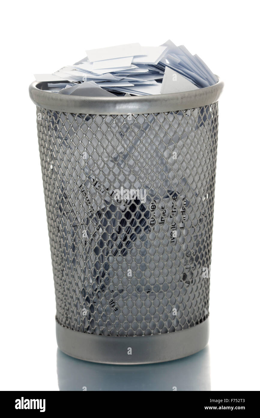 Mesh trash bin full of paper Stock Photo - Alamy