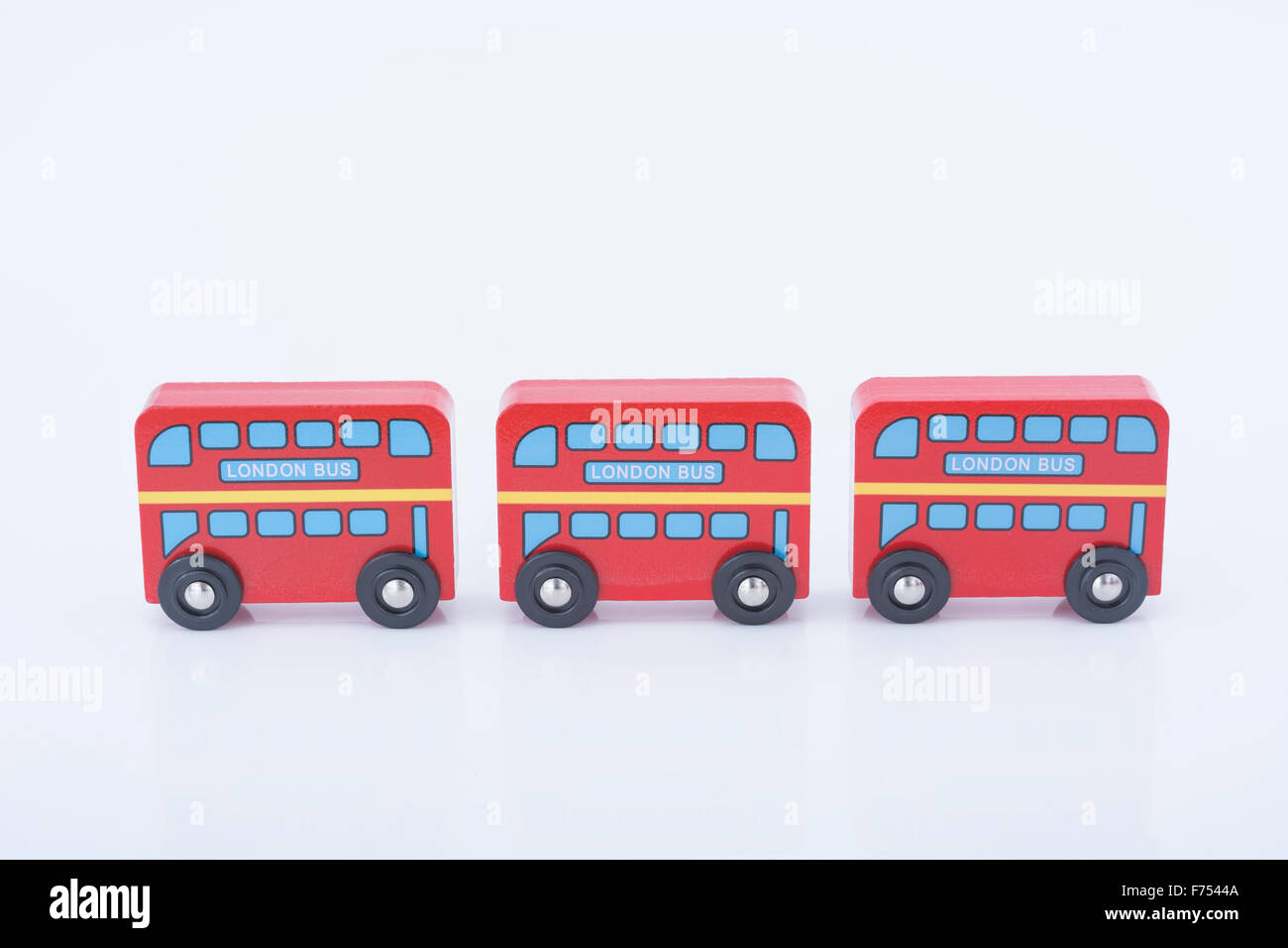 Red London bus wooden toys on white background - for London Transport ...