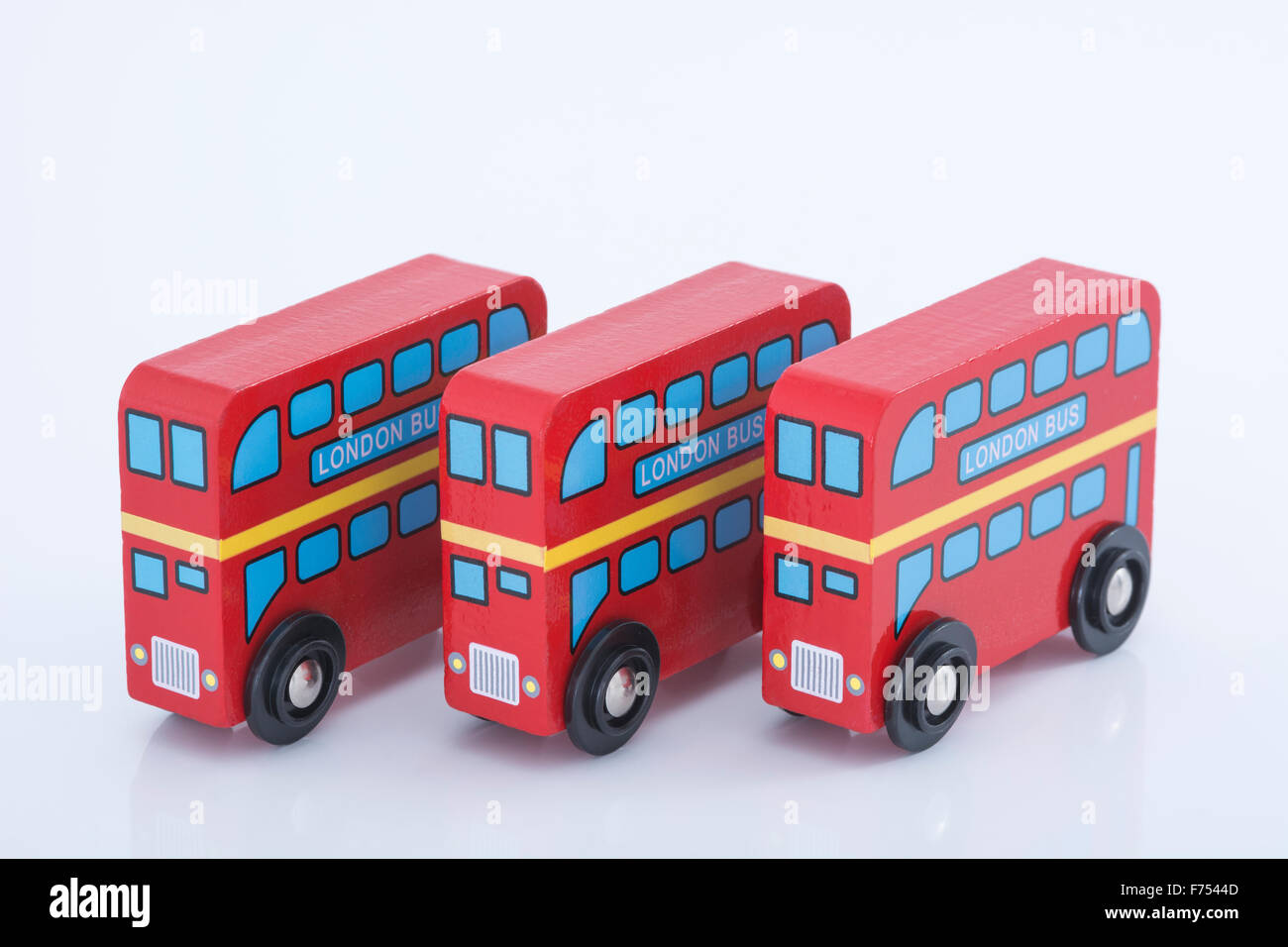 Red London bus wooden toys on white background - for London Transport ...
