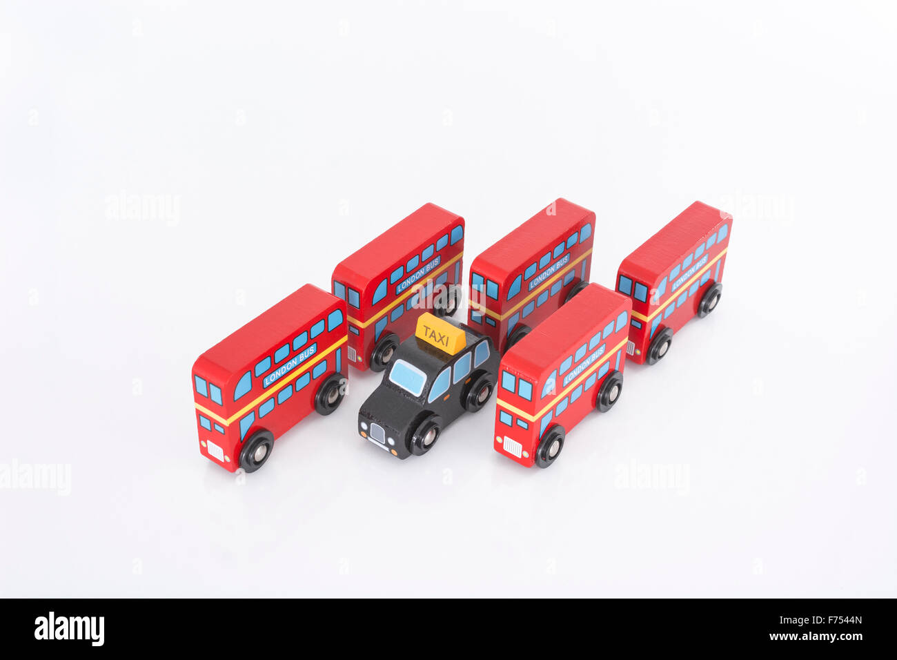 Red London buses & black cab (taxi) wooden toys on white background ...