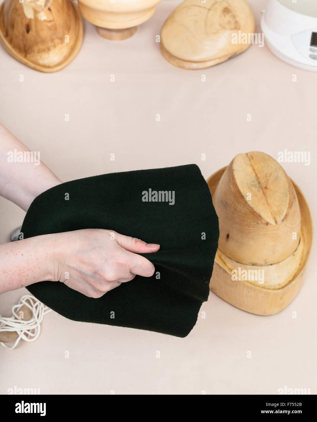 workshop for alpine felt hat making - hatter preparing a felt hood for ...