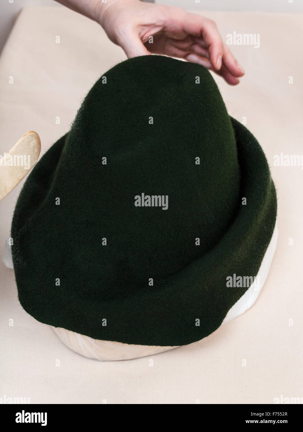 workshop for alpine felt hat making - hatter fixes a felt hood on ...