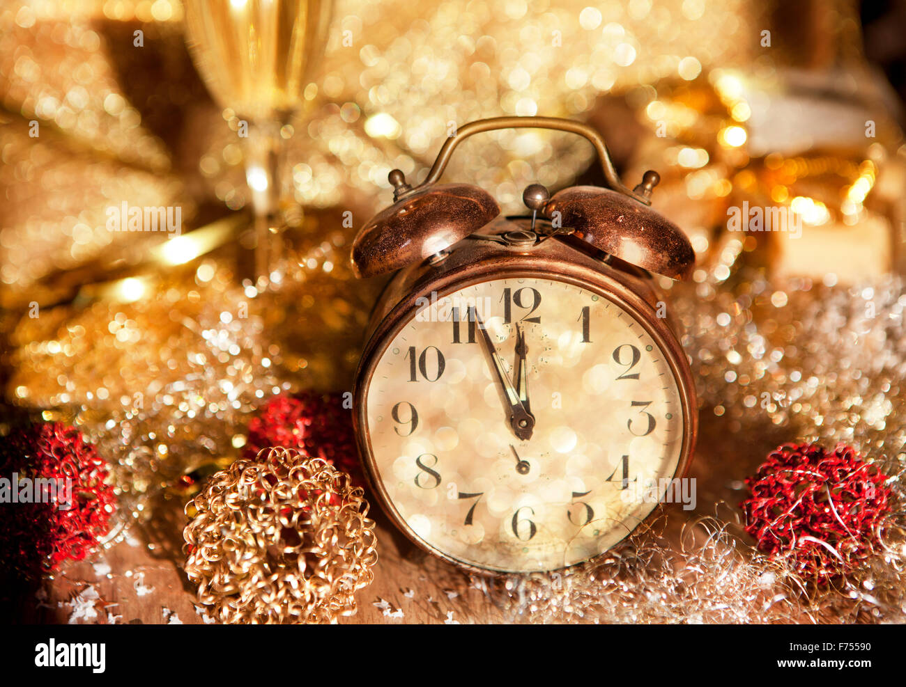 a clock displays just before New Year, in the background champagne and ...
