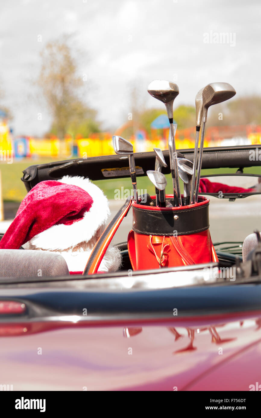 Santa in convertible with golf clubs Stock Photo - Alamy