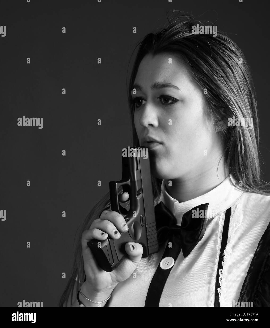 Beautiful young woman in costume with a faux gun Stock Photo - Alamy