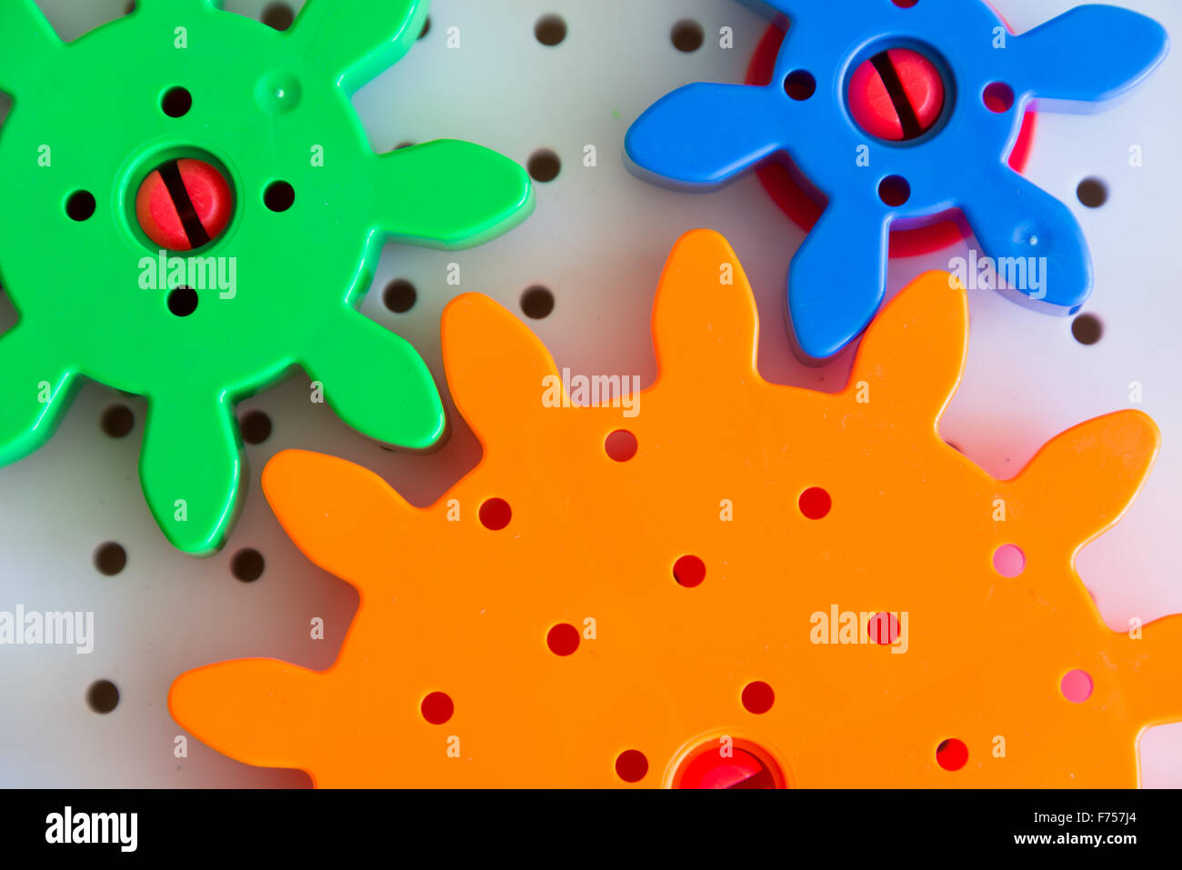 Gears from colorful children game Stock Photo - Alamy
