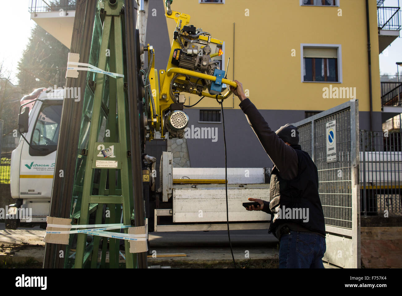 Construction workers installing new windows in a house under ...