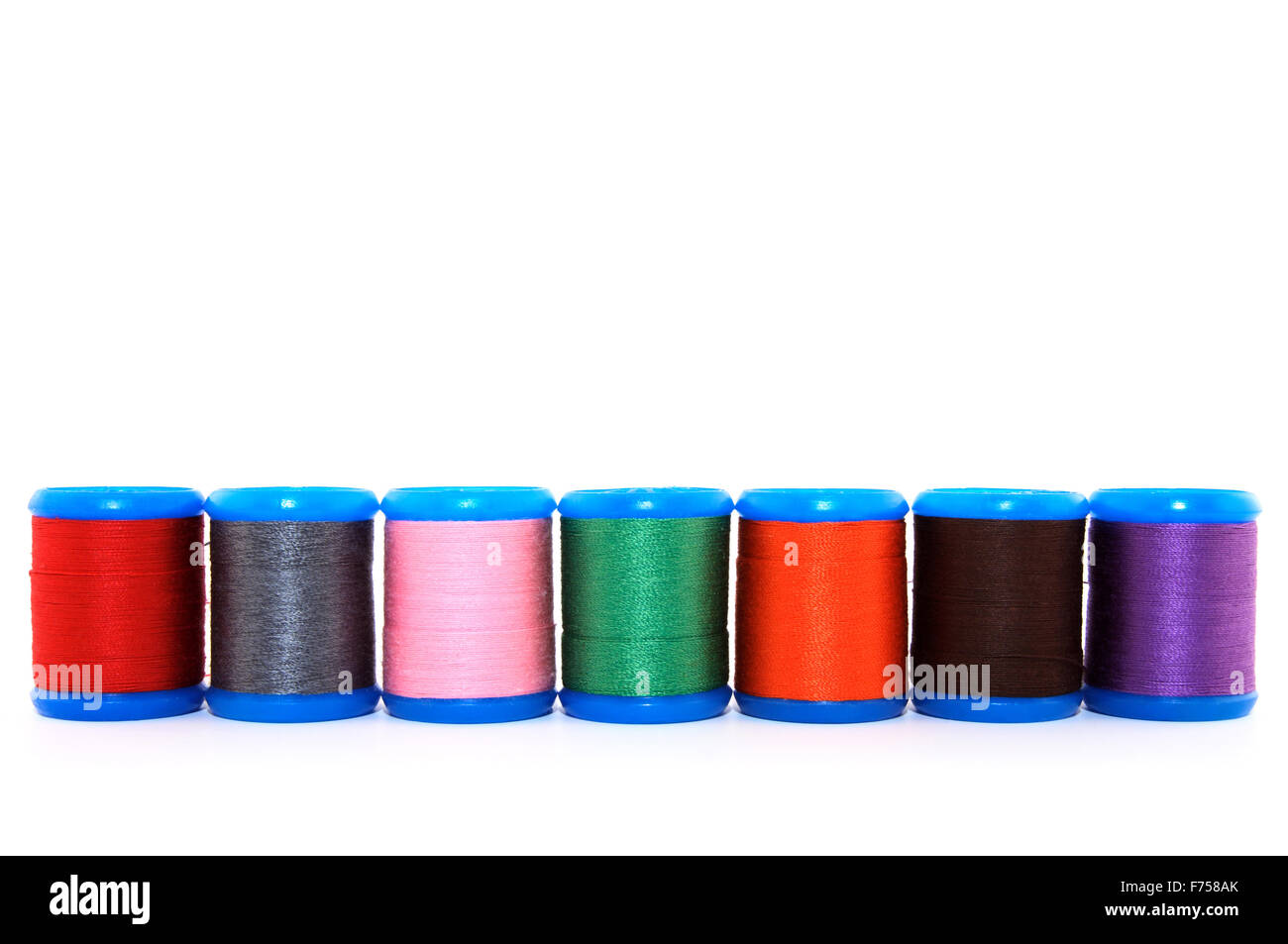 Row of colorful thread spools Stock Photo - Alamy