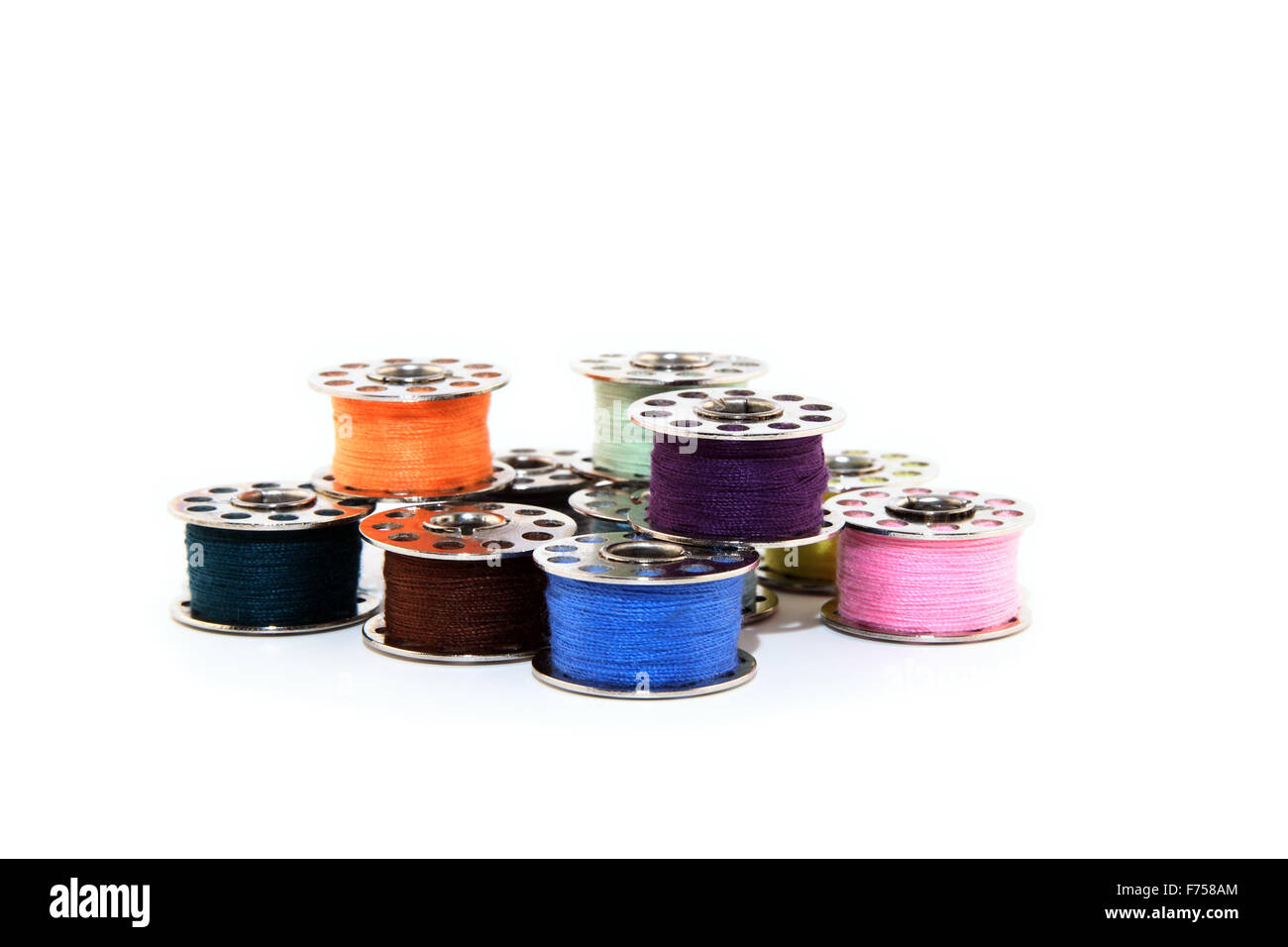 Multicolored spools sewing threads Cut Out Stock Images & Pictures - Alamy