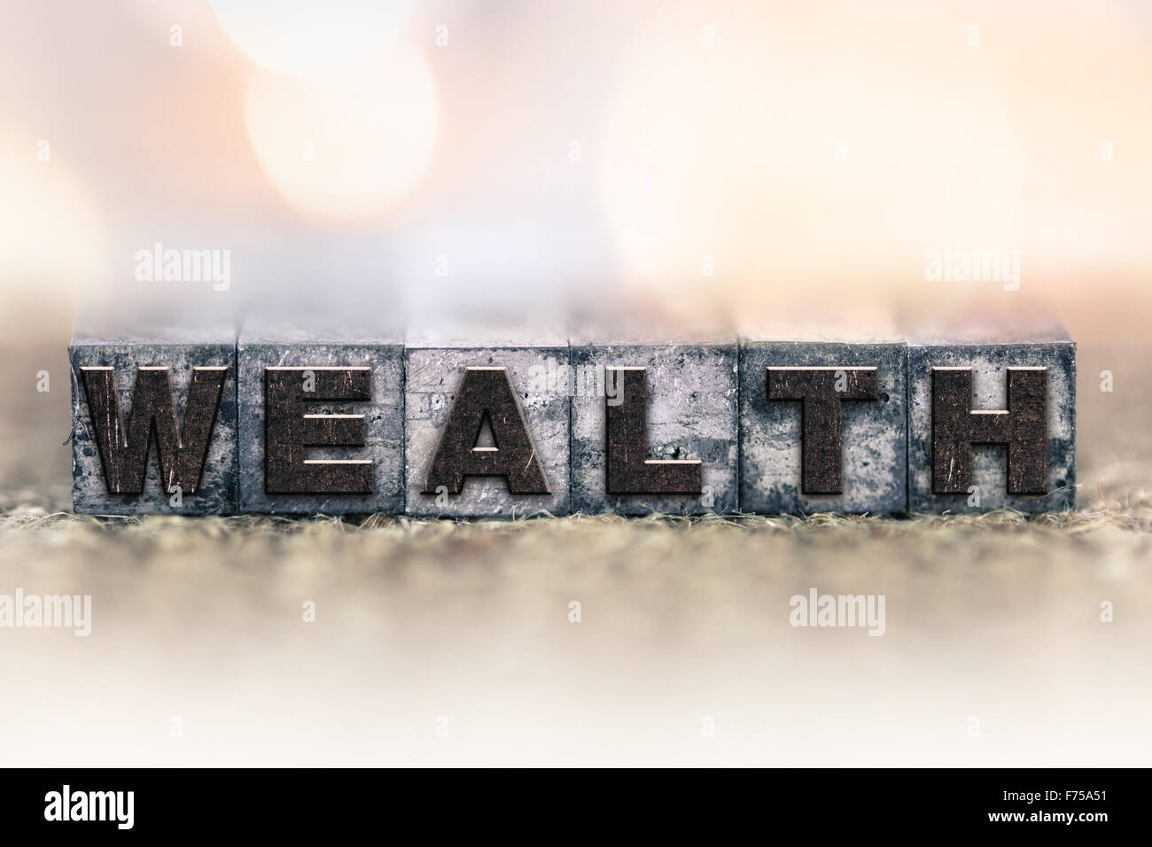 The word "WEALTH" written in vintage ink stained letterpress type Stock ...