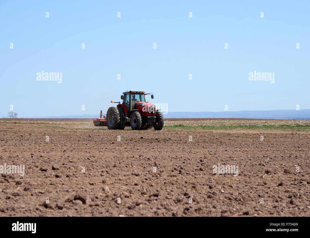 Tractor plowing land Stock Photo - Alamy