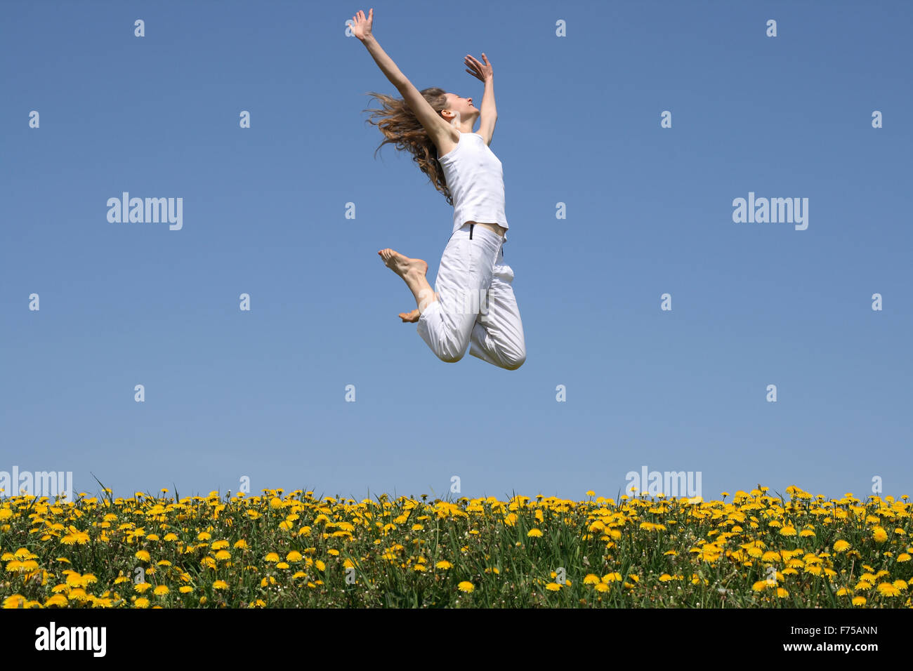 Girl in a happy jump Stock Photo - Alamy
